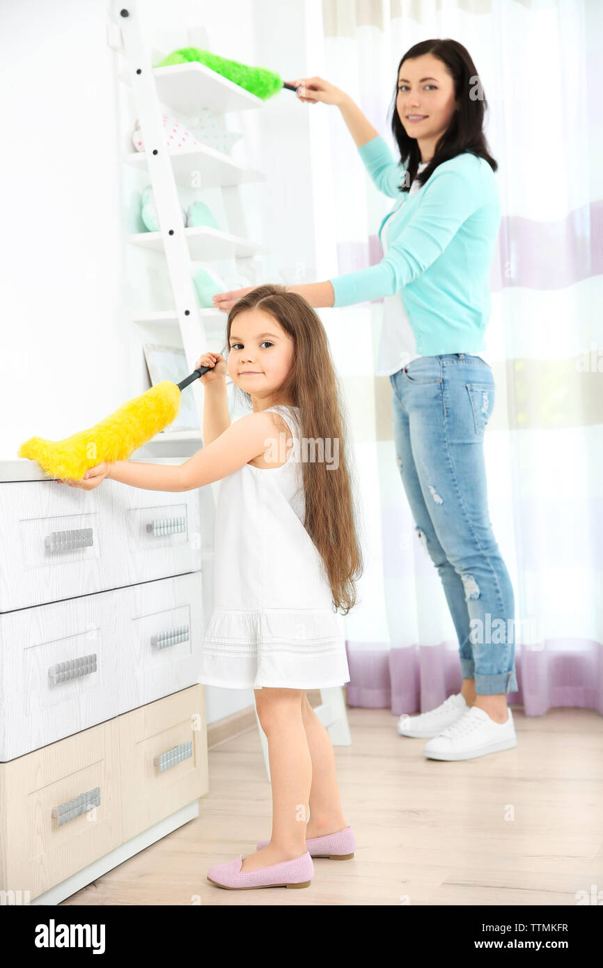 Daughter and mother cleaning dust in room Stock Photo - Alamy