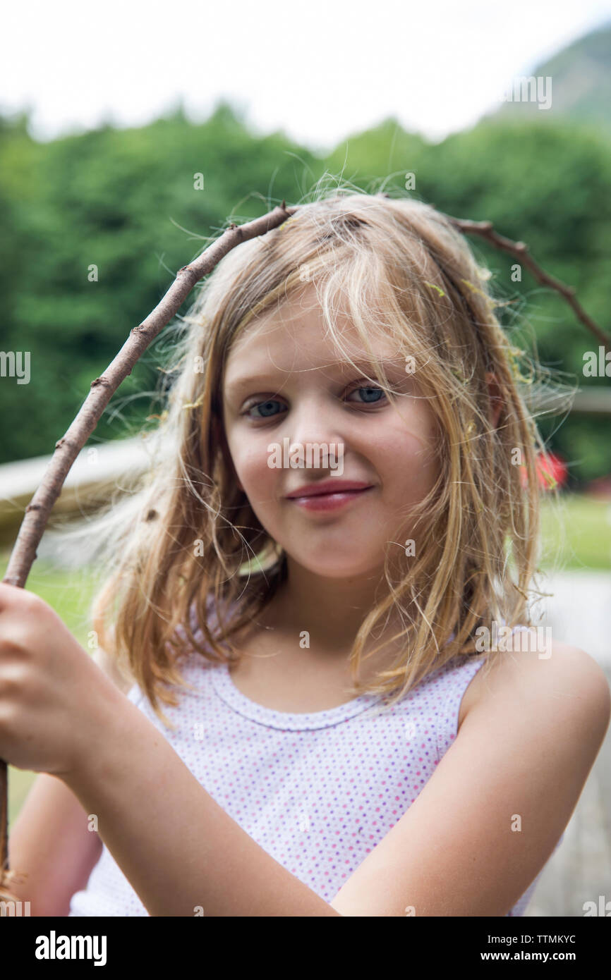 CANADA, Vancouver, British Columbia, a young girl holding a stick at ...