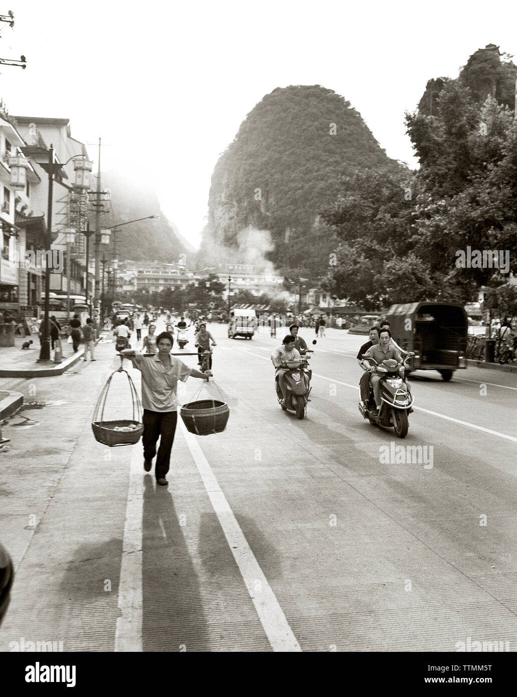 CHINA, Guilin, people work, walk and ride motorbikes on the streets of ...
