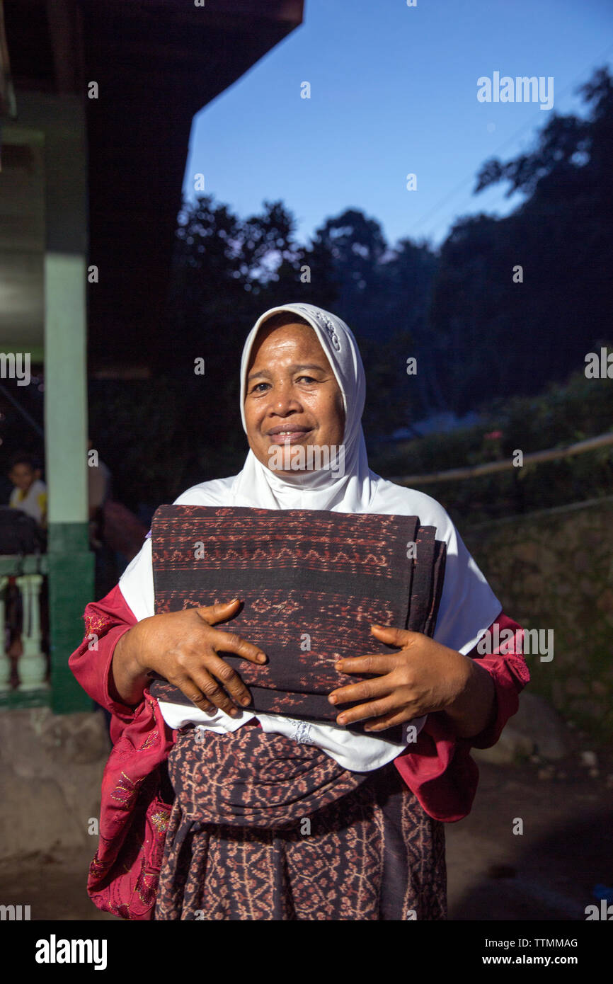 INDONESIA, Flores, a woman weaver in the town of Ende, a member of a ...