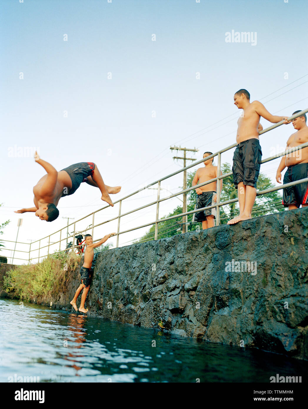 USA, Hawaii, The Big Island, a group of kids play in the Ice Pond in ...