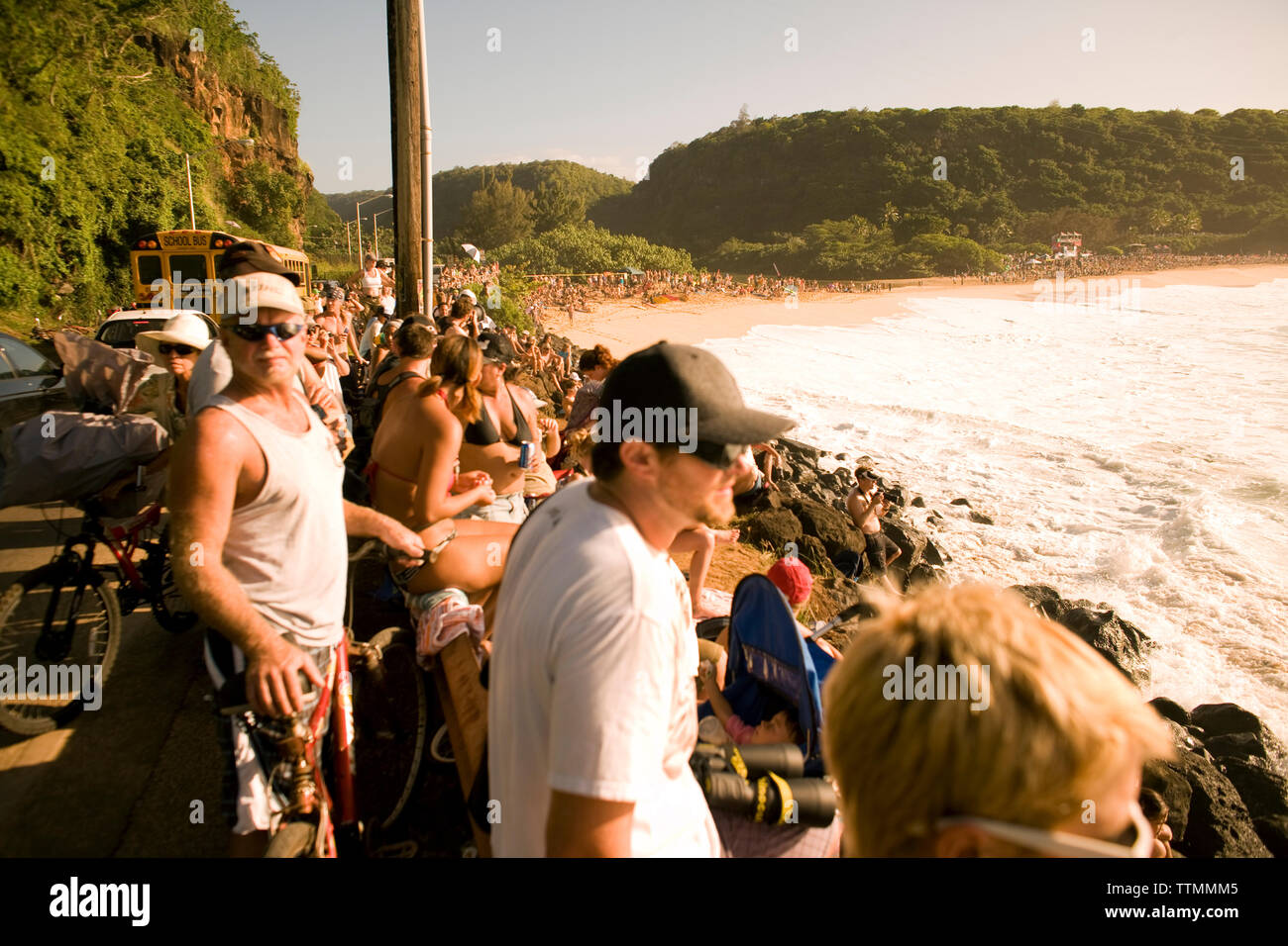 USA, Hawaii, Oahu, large crowd of people watch the Eddie Aikau surfing ...