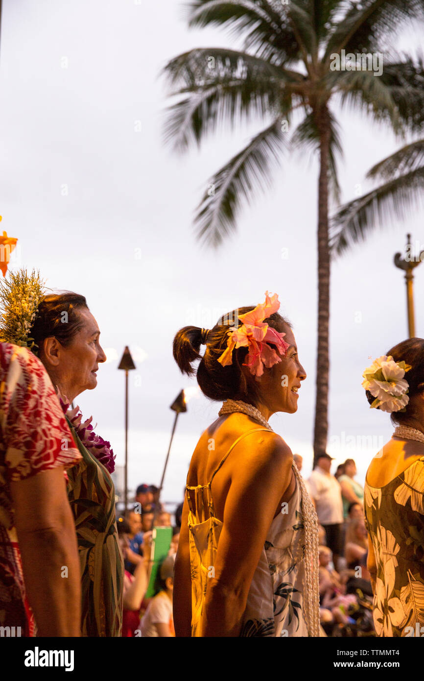 USA, Oahu, Hawaii, hula dancers perform for tourists at Waikiki Beach ...