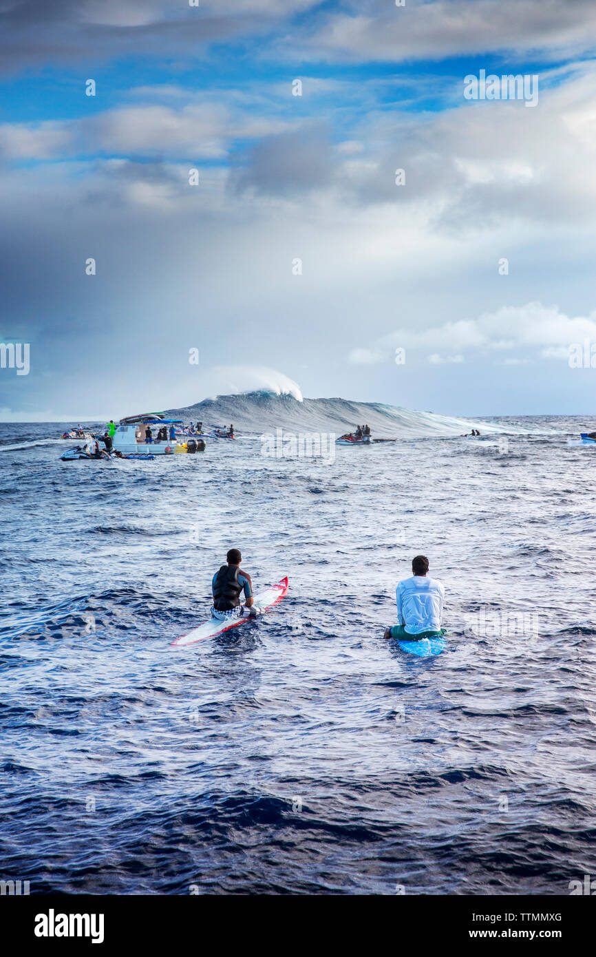 USA, HAWAII, Maui, Jaws, surfers and boats in the water at Peahi on the ...
