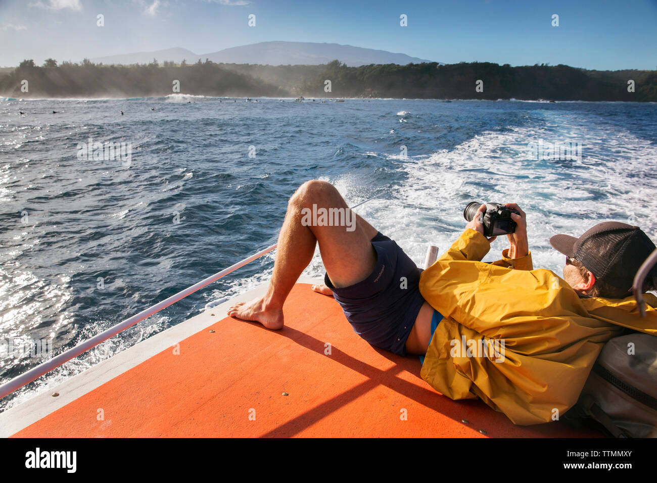 USA, HAWAII, Maui, Jaws, big wave surfer Kohl Christensen taking photos ...