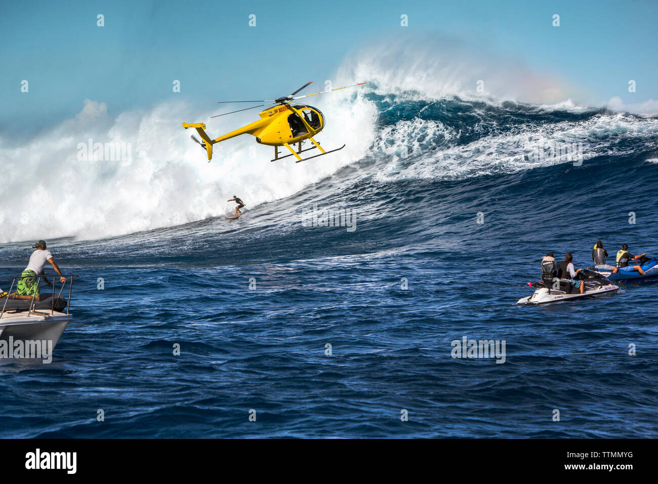 USA, HAWAII, Maui, Jaws, a helicopter hovering over the big waves and ...