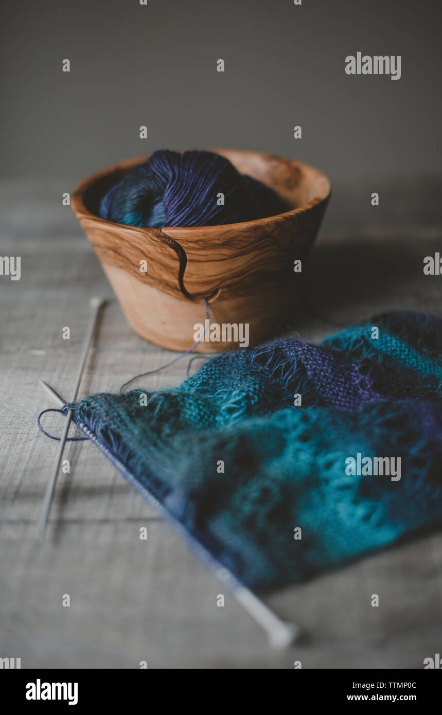 Close-up of knitted wool with needles on table Stock Photo - Alamy