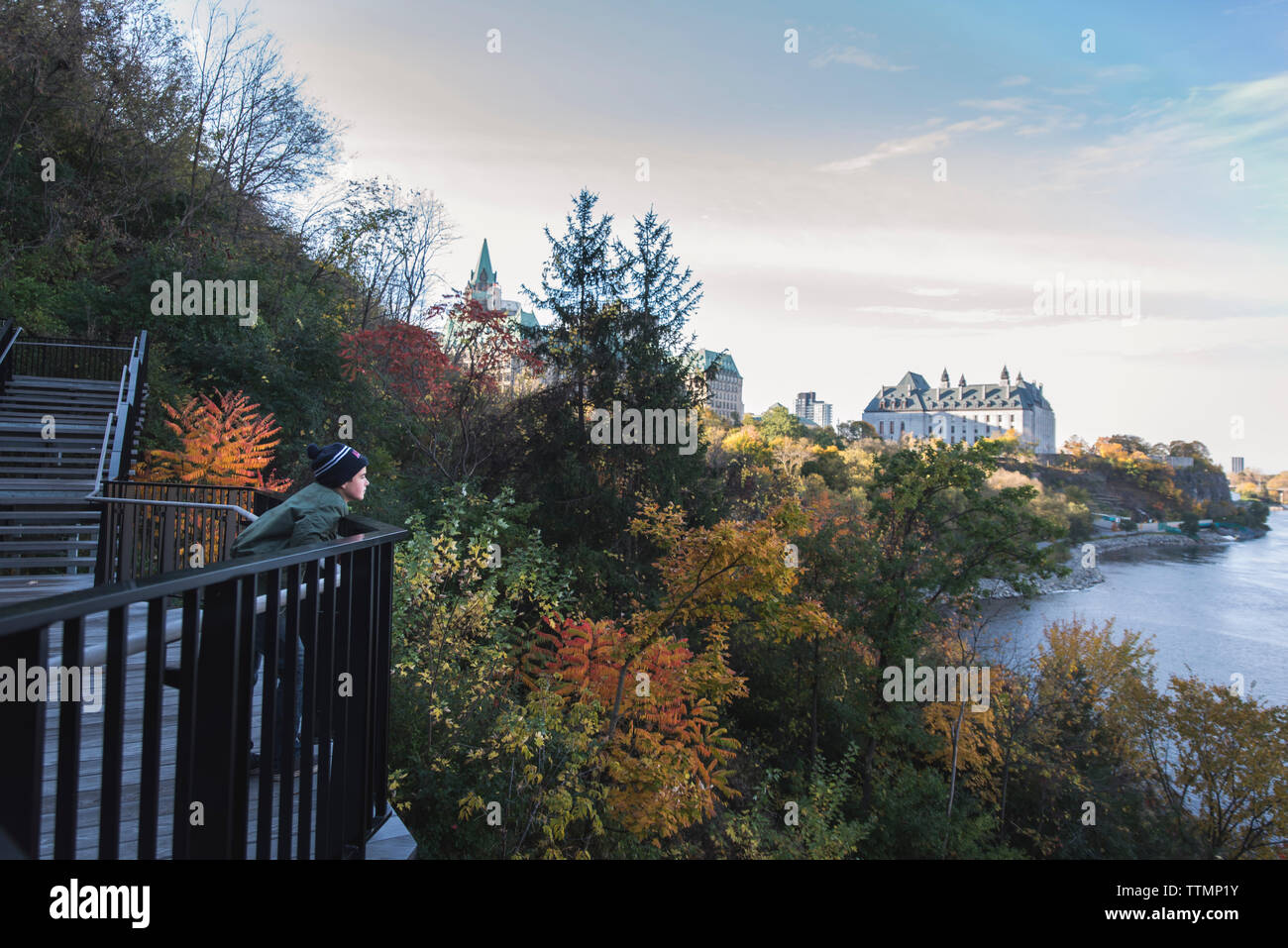 Boy leaning railing outdoors hi-res stock photography and images - Alamy