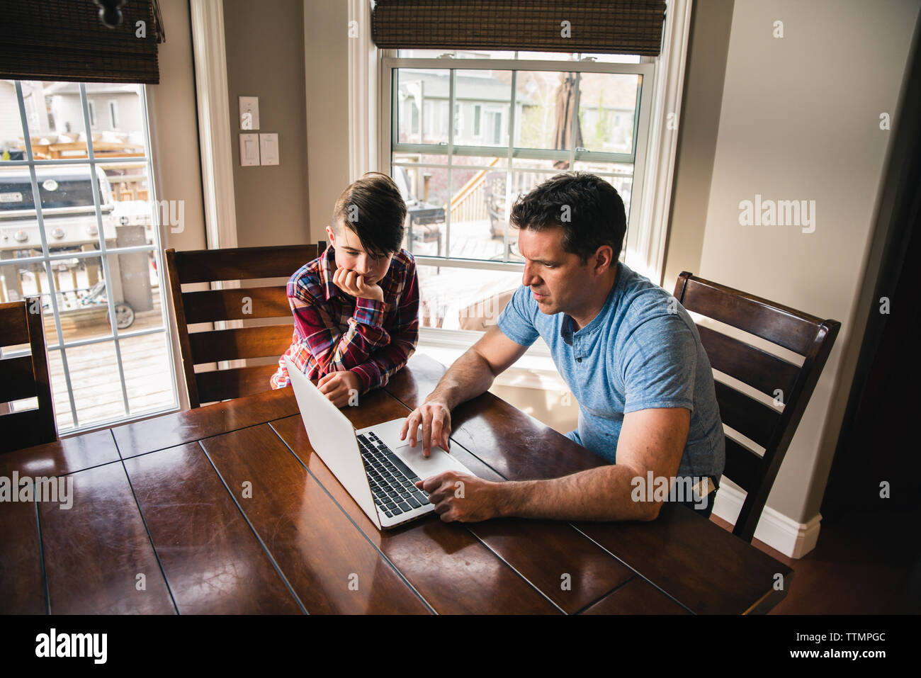 Father son using laptop together hi-res stock photography and images ...