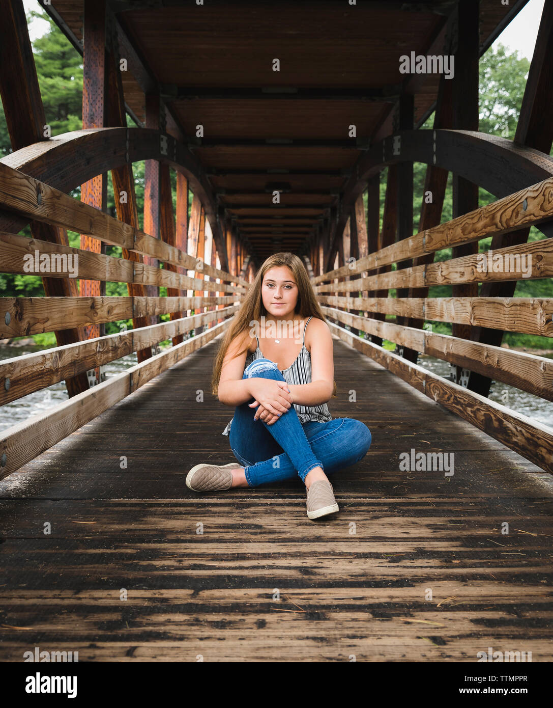Woman Sitting On Bridge