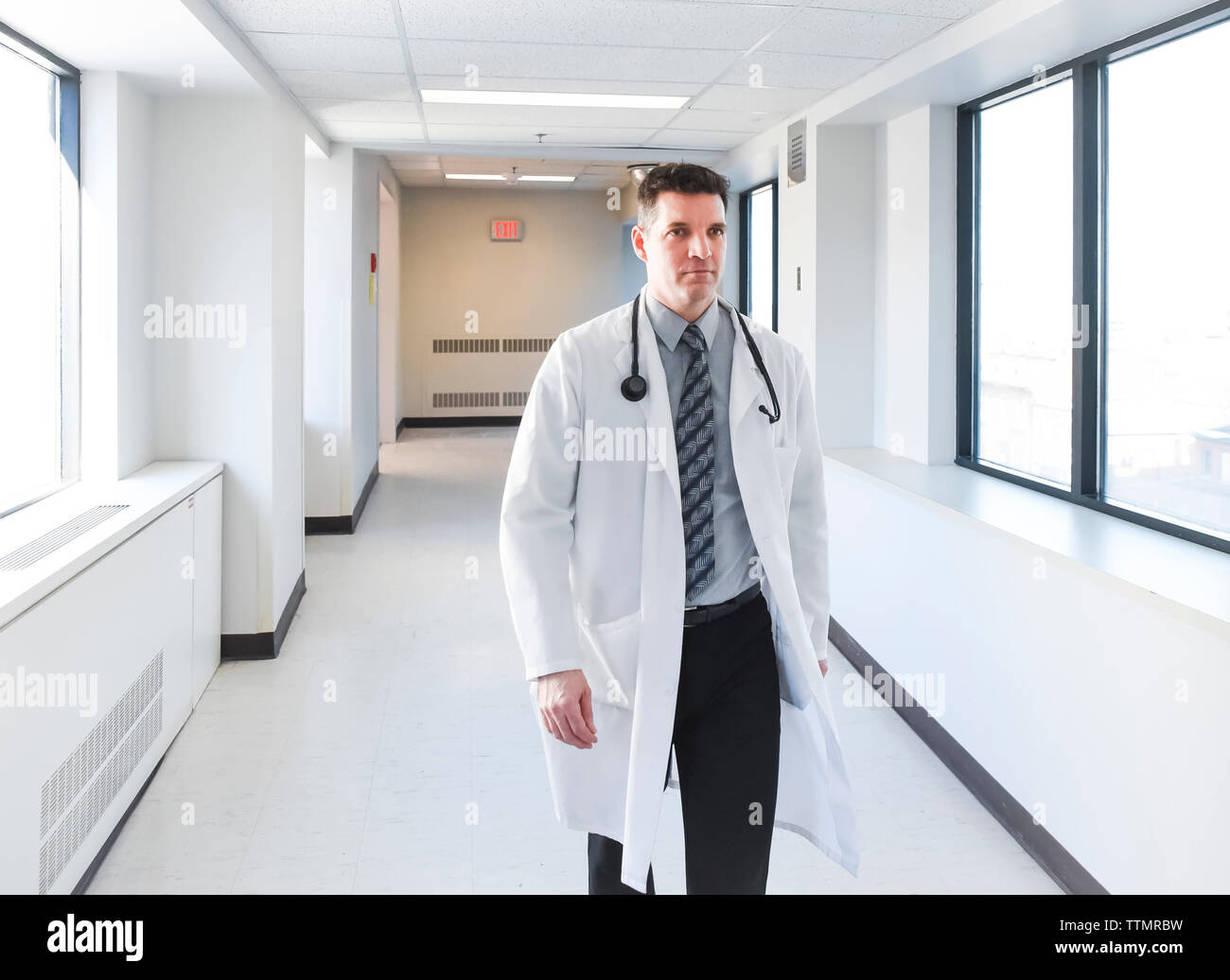 Doctor walking in hallway hi-res stock photography and images - Alamy