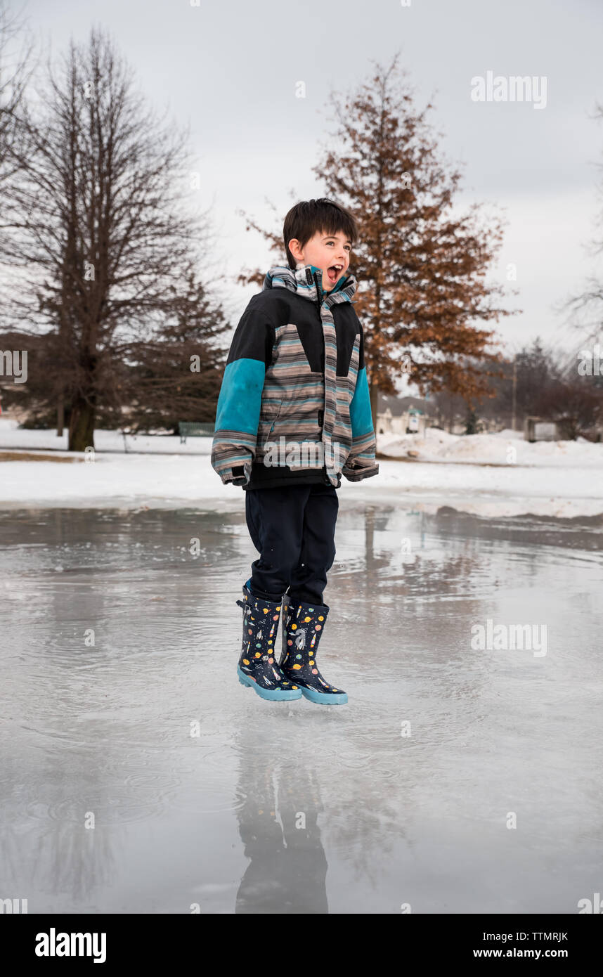 Child jumping in puddle hi-res stock photography and images - Alamy