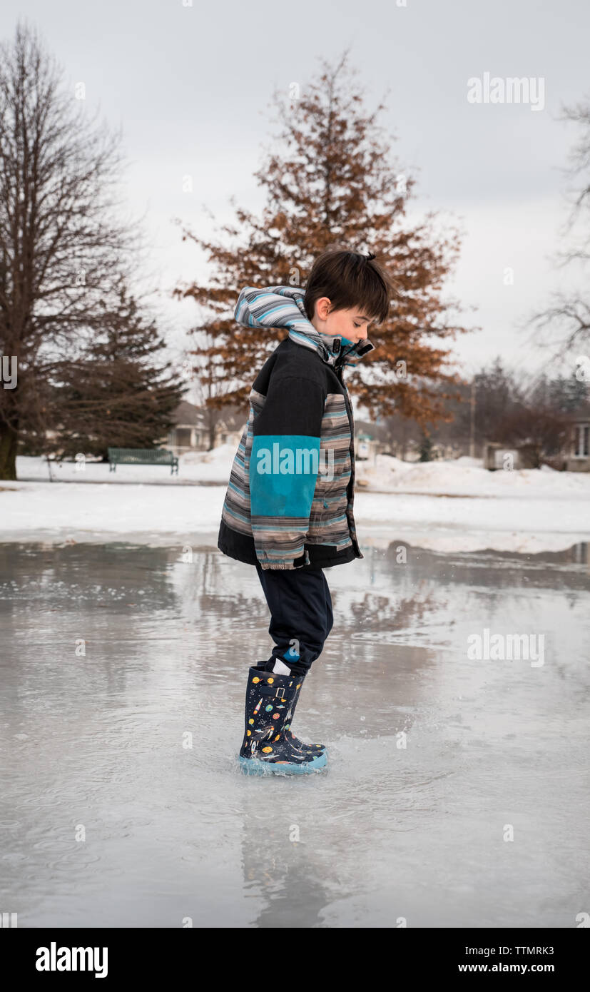 Child jumping in puddle hi-res stock photography and images - Alamy