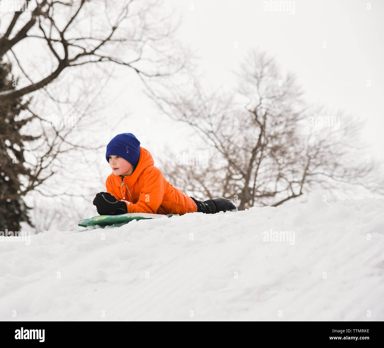 Boy with sled hi-res stock photography and images - Alamy