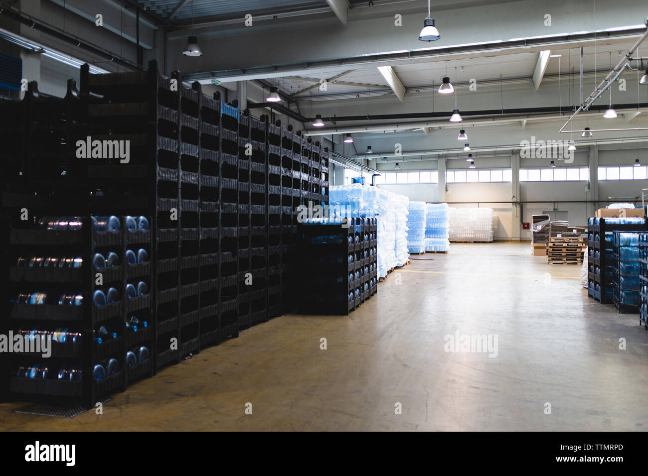 Crates of water bottles in warehouse Stock Photo - Alamy