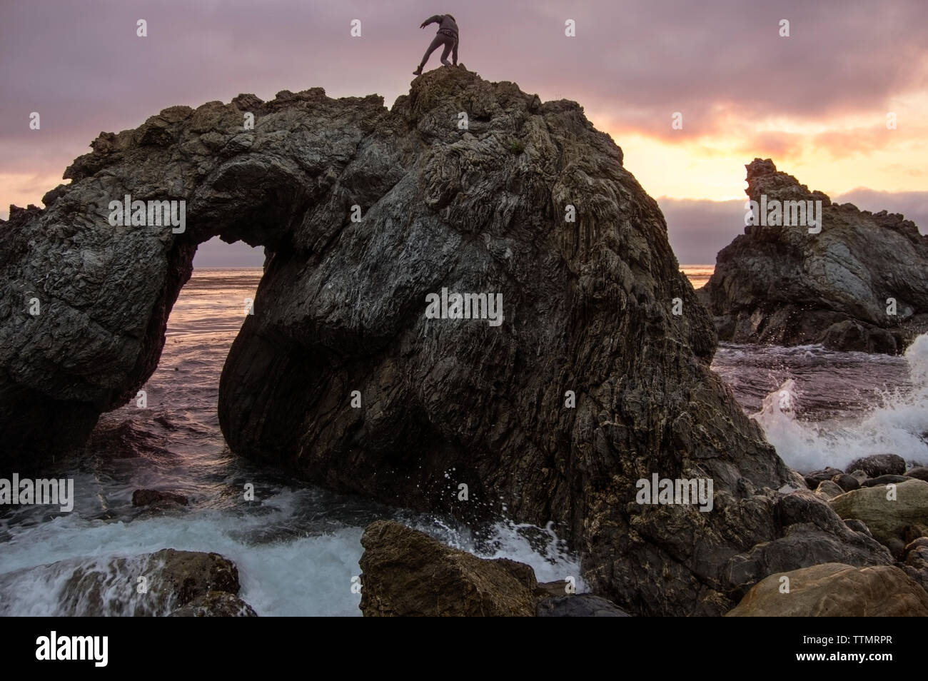 Woman standing rock arch hi-res stock photography and images - Alamy