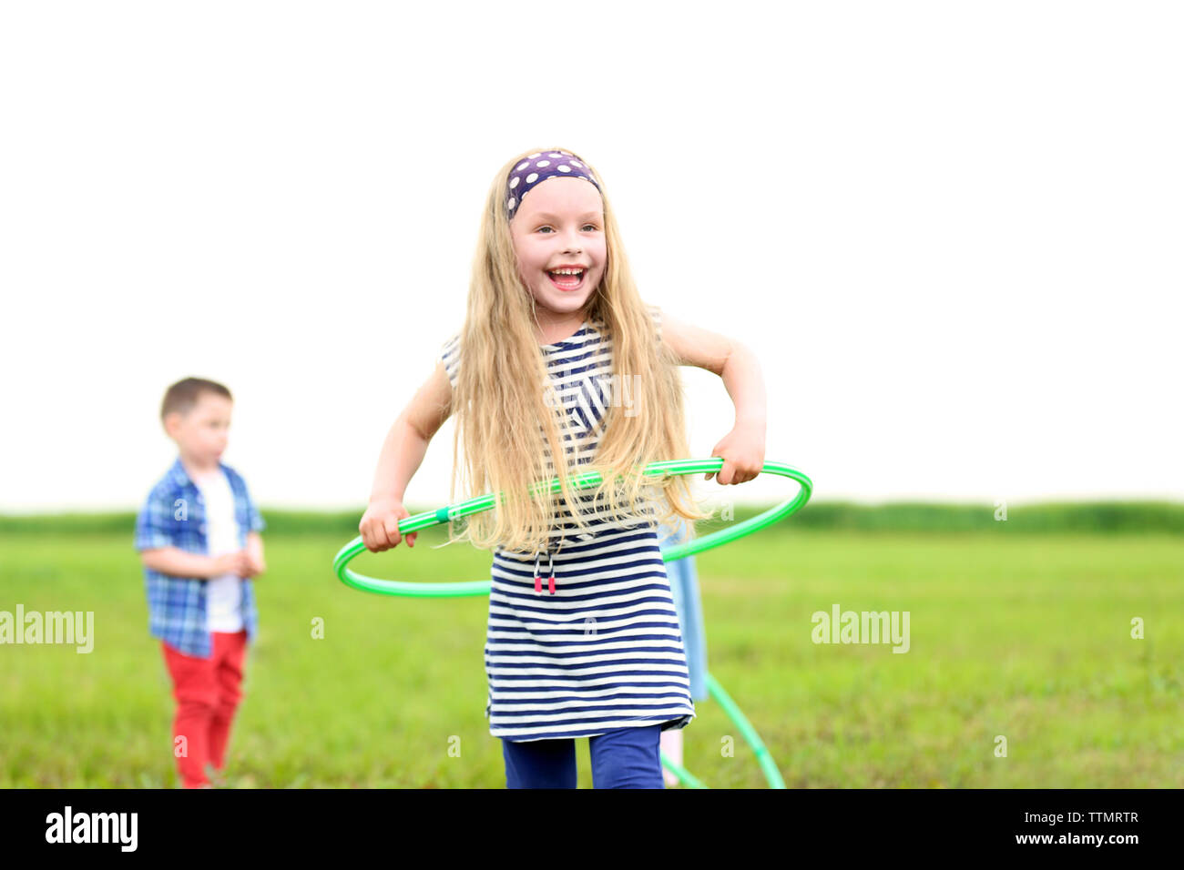 Children having fun with hula hoops outdoor Stock Photo - Alamy