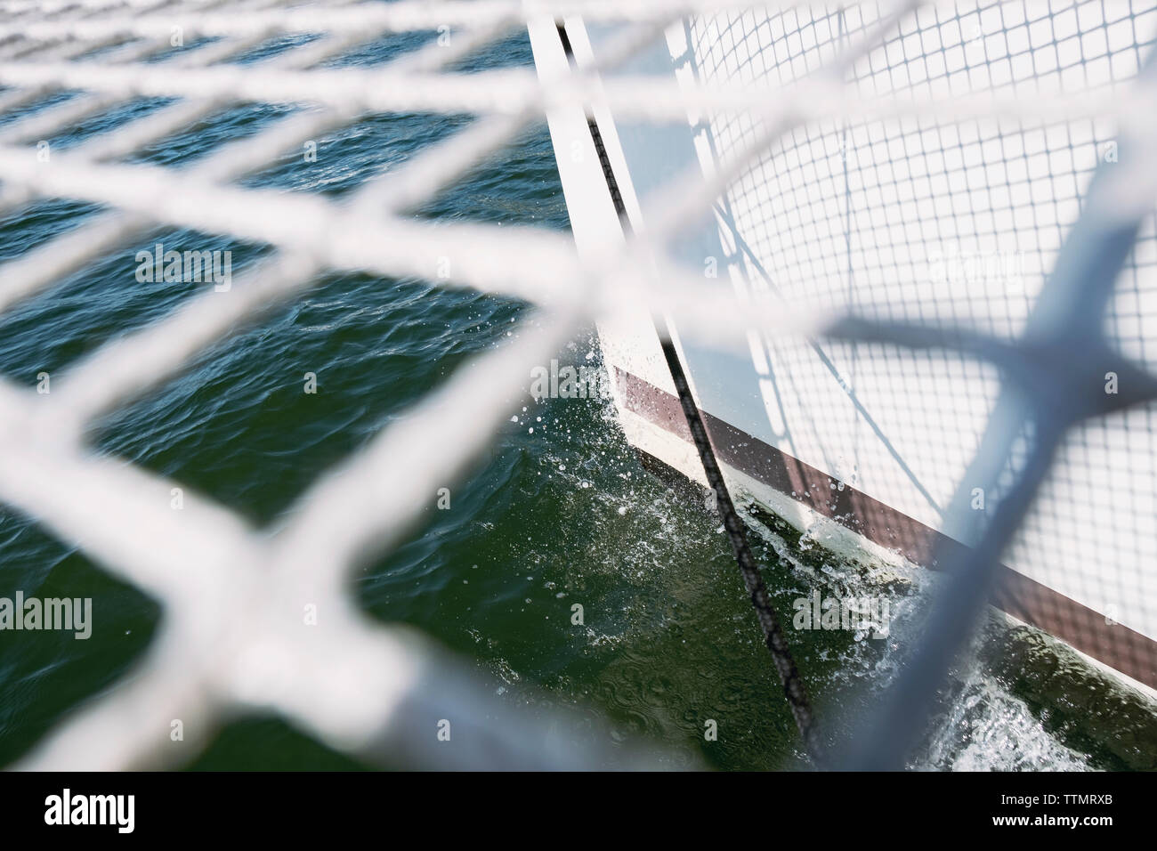 Boat sailing in sea seen through net Stock Photo - Alamy