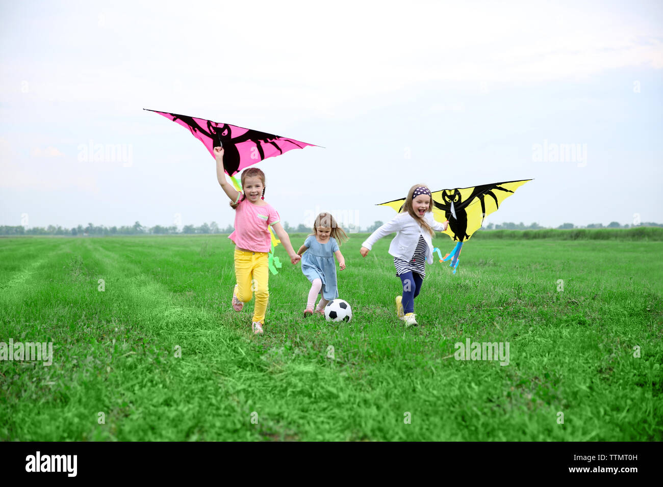 Children having fun with toys outdoor Stock Photo - Alamy