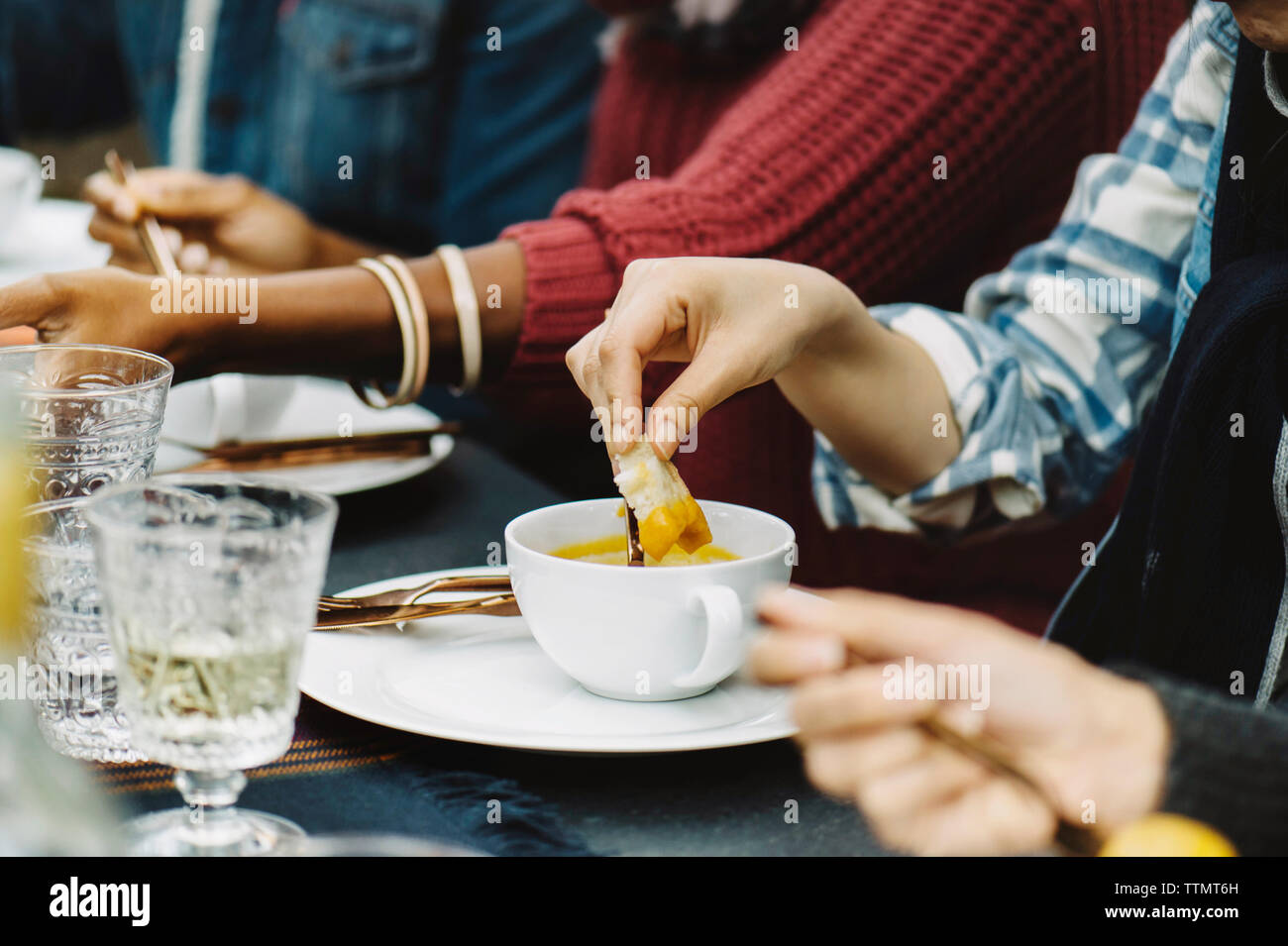 Woman dipping slice bread hi-res stock photography and images - Alamy
