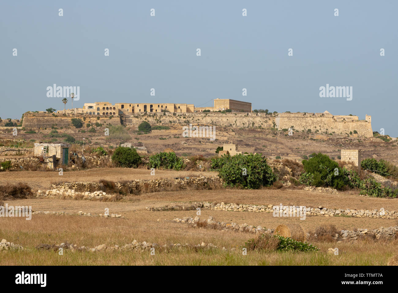 Looking across farming fields to Fort Chambray, Gozo Stock Photo - Alamy