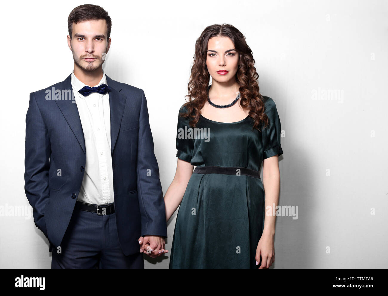 Elegant couple on light background Stock Photo - Alamy
