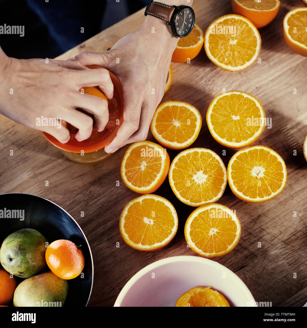 Directly above view of hands squeezing oranges Stock Photo - Alamy
