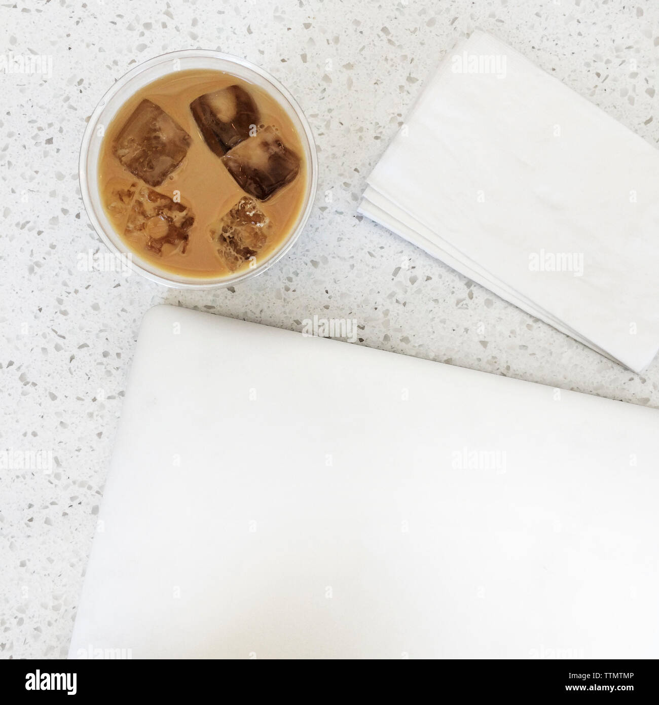 Laptop, napkin and iced coffee Stock Photo - Alamy