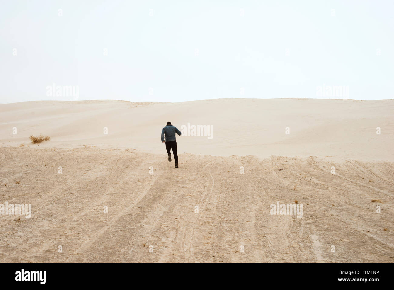 Male running through desert hi-res stock photography and images - Alamy