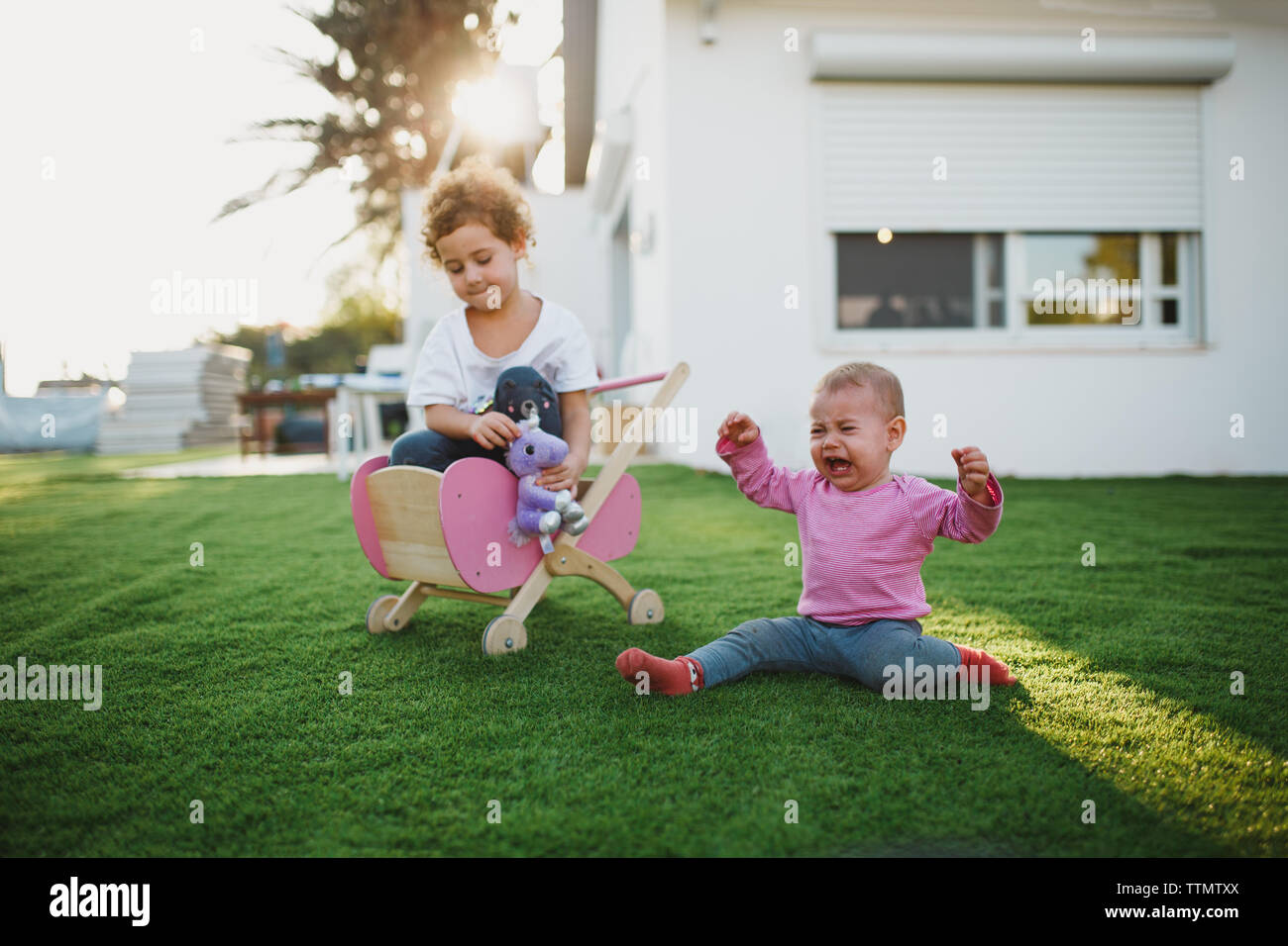 Girls fighting over doll hi-res stock photography and images - Alamy