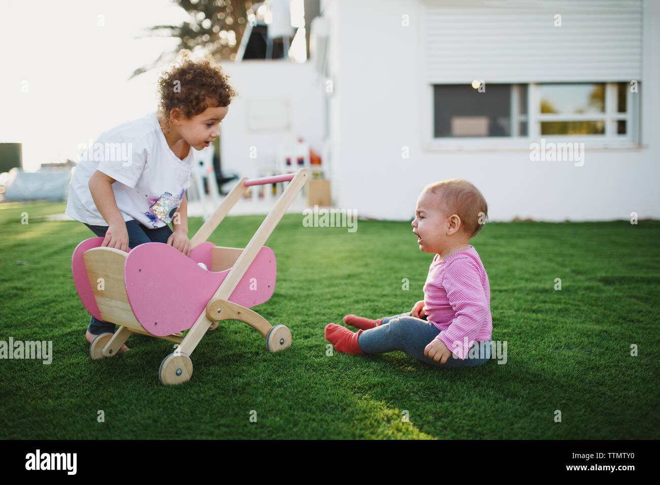 Girls fighting over doll hi-res stock photography and images - Alamy