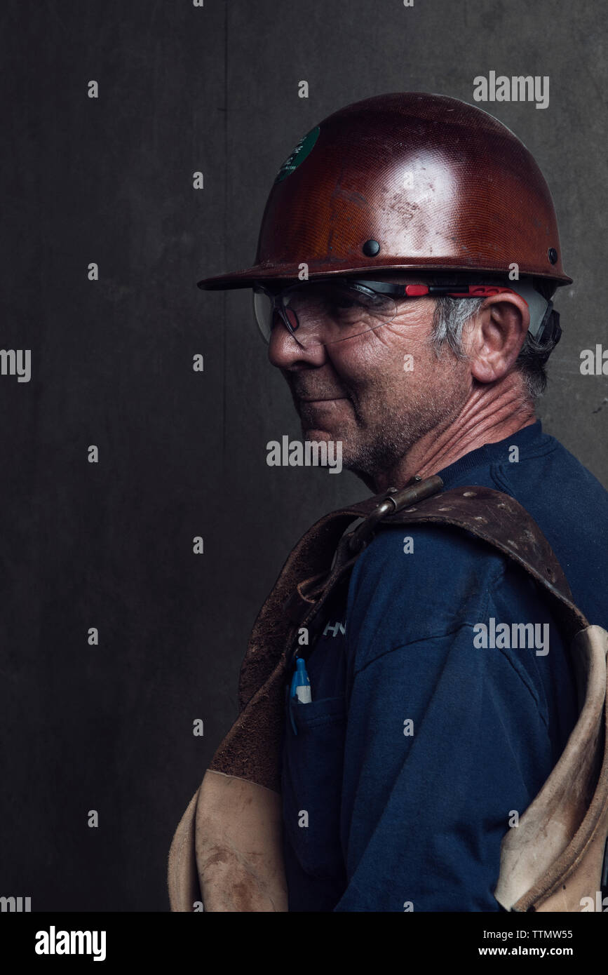Man wearing safety helmet and protective eyewear Stock Photo - Alamy