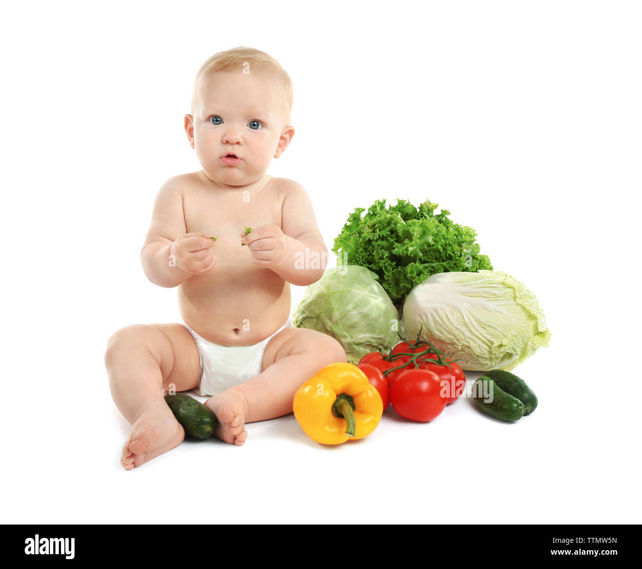 Cute baby and fresh vegetables on white background Stock Photo - Alamy