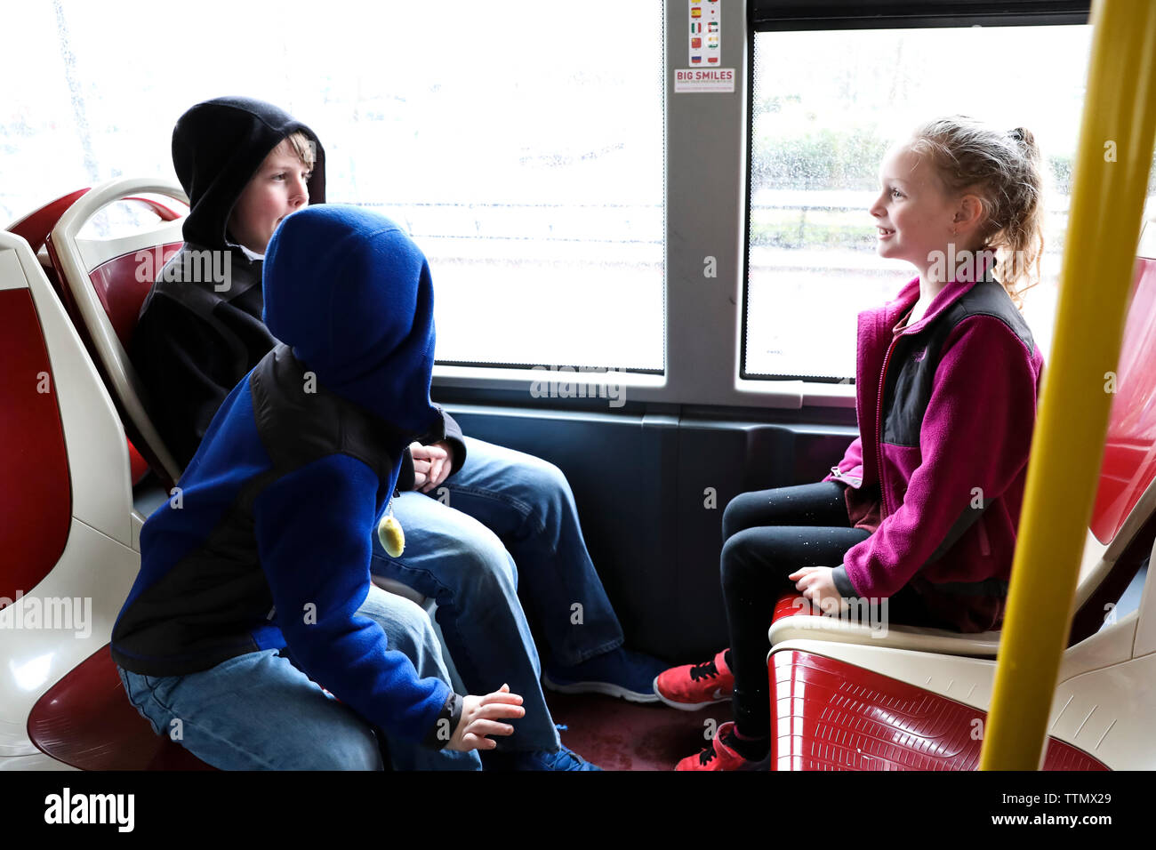 Happy Siblings Sit on the Lower Level of Double Decker Bus Stock Photo ...