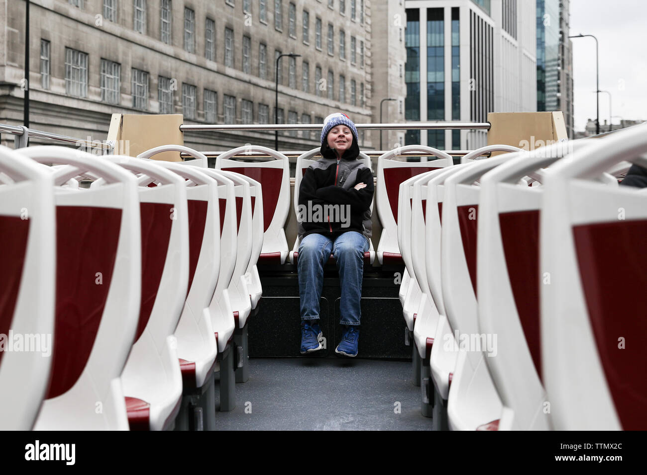 Happy Tween Boy Sits Alone in Back Row on Top of Double Decker Bus ...