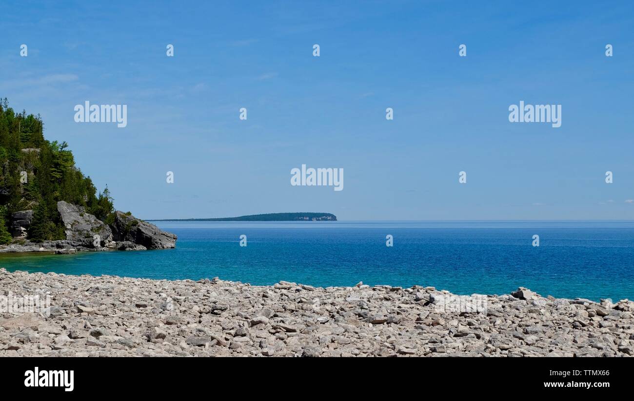 rocky beach and smooth water Stock Photo - Alamy