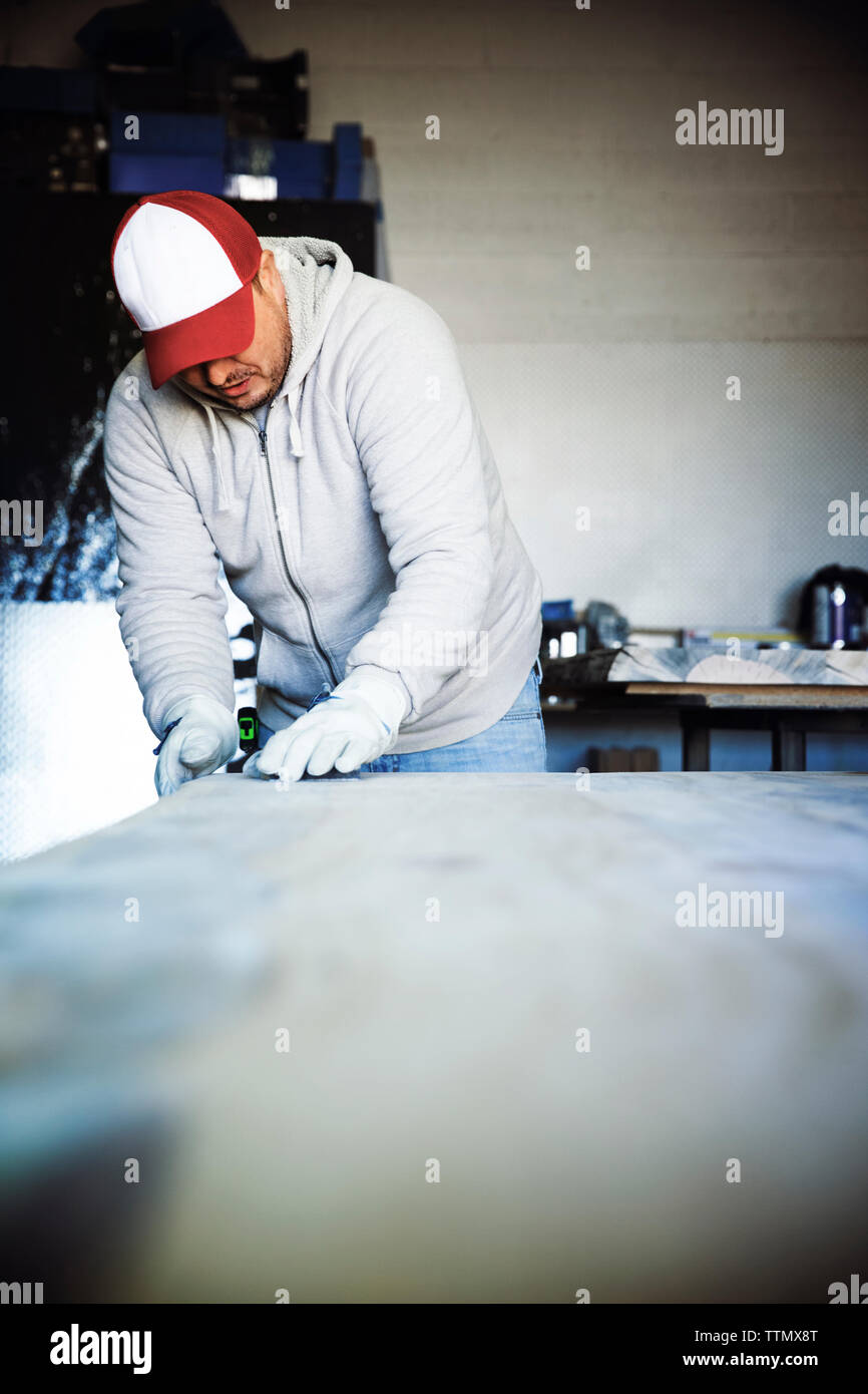 Craftsman checking quality of wood at workshop Stock Photo - Alamy