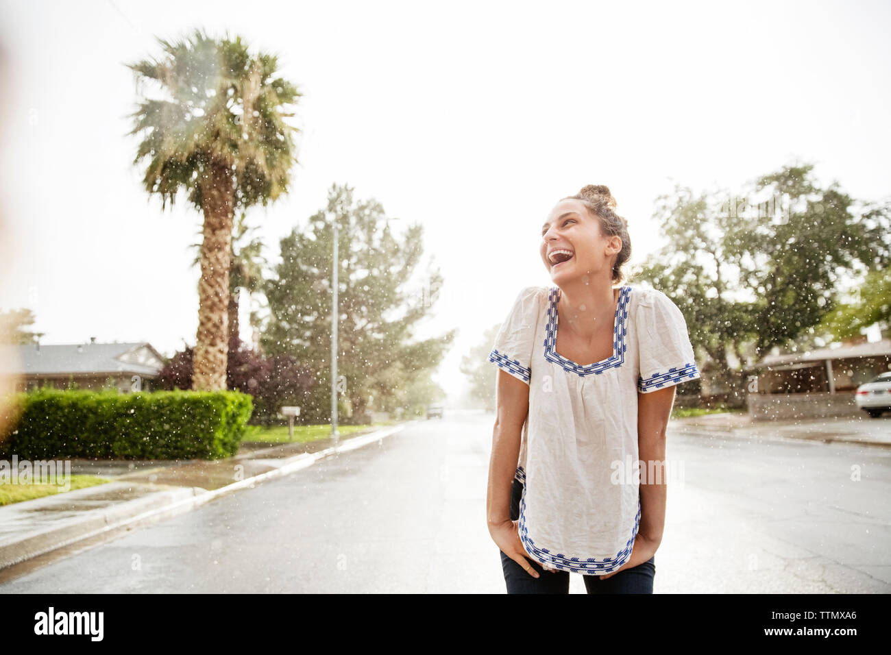 Woman standing by road hi-res stock photography and images - Alamy