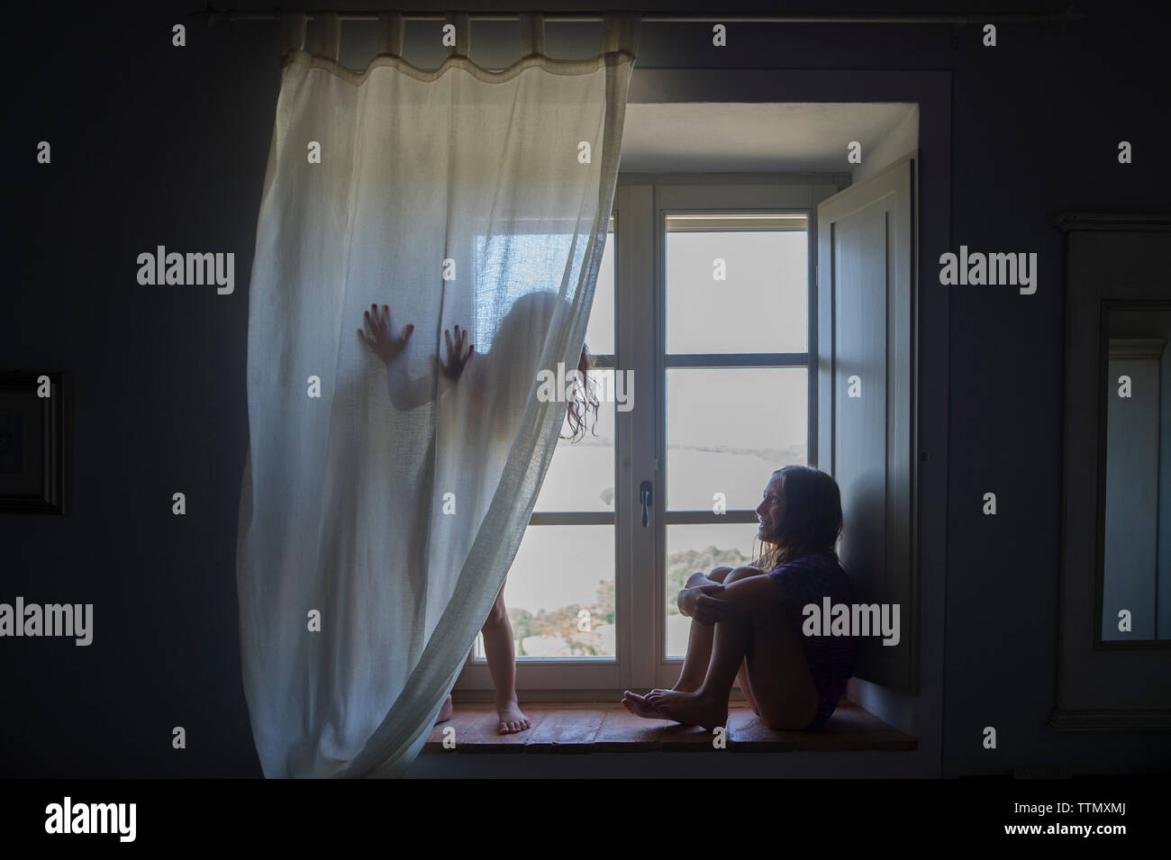 Siblings on window sill hi-res stock photography and images - Alamy