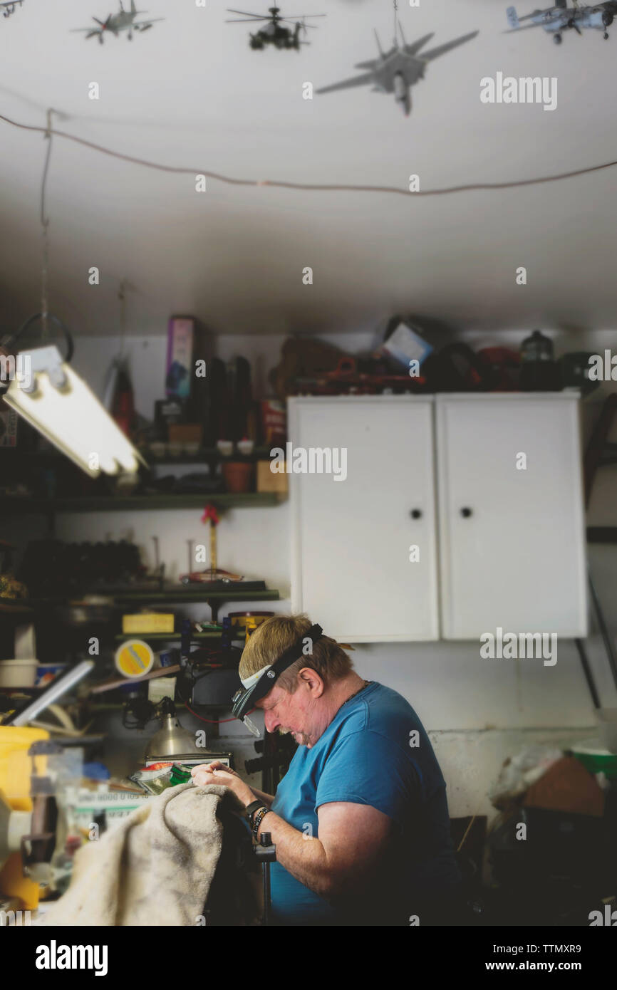Side view of worker at workshop Stock Photo - Alamy
