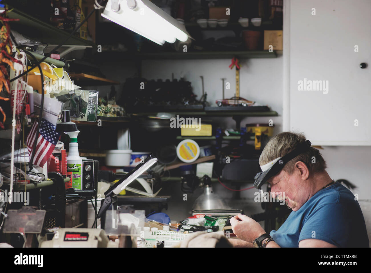 Side view of worker working at workshop Stock Photo - Alamy
