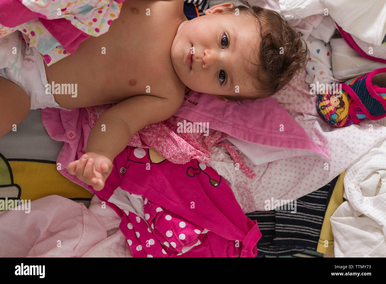 messy girl clothes on top of her mother's bed Stock Photo - Alamy