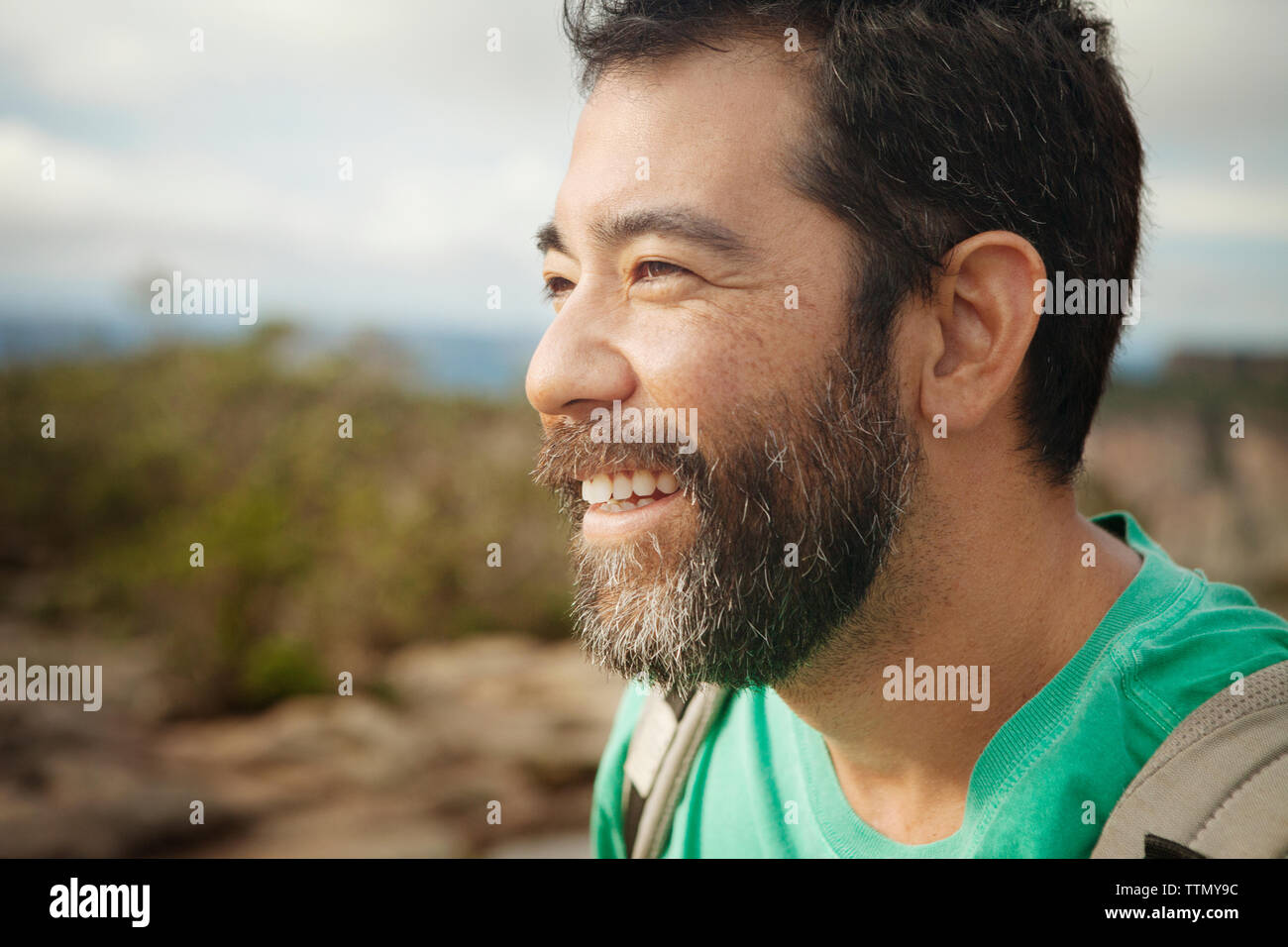 Side-view of hiker smiling Stock Photo - Alamy