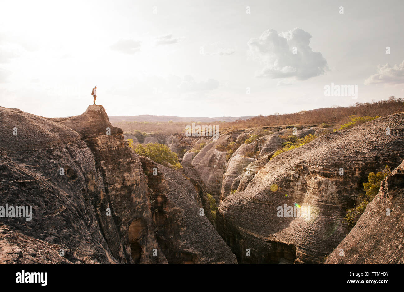 Man standing on rock Stock Photo - Alamy