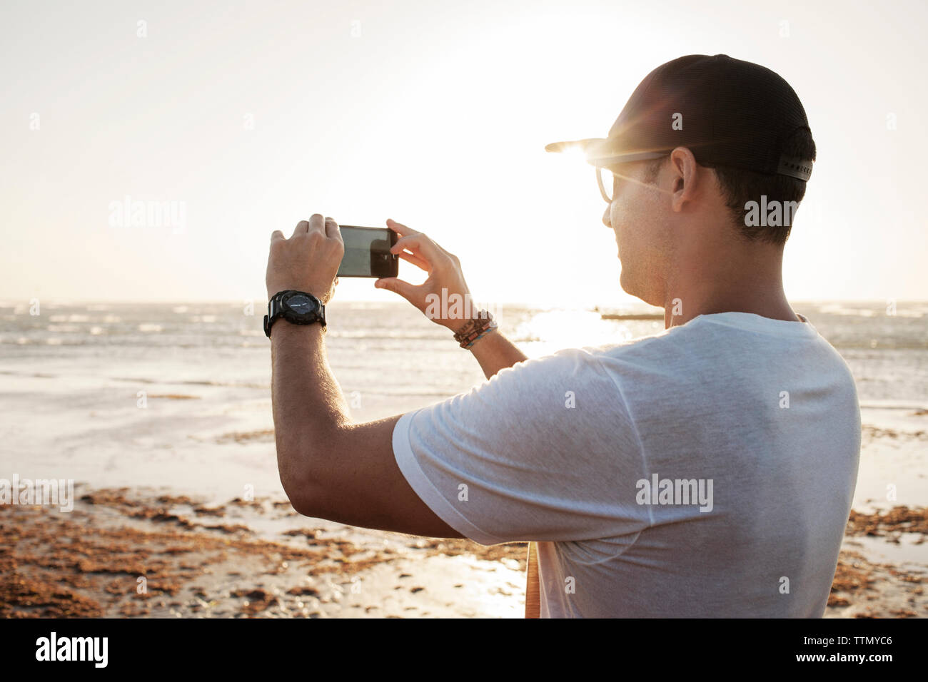 Man taking picture with phone Stock Photo - Alamy