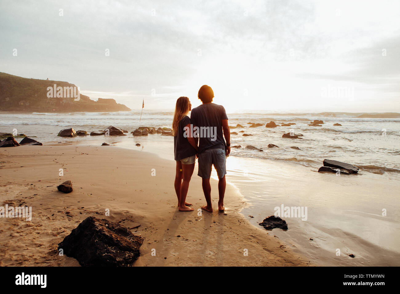 Couple standing beach outdoors hi-res stock photography and images - Alamy
