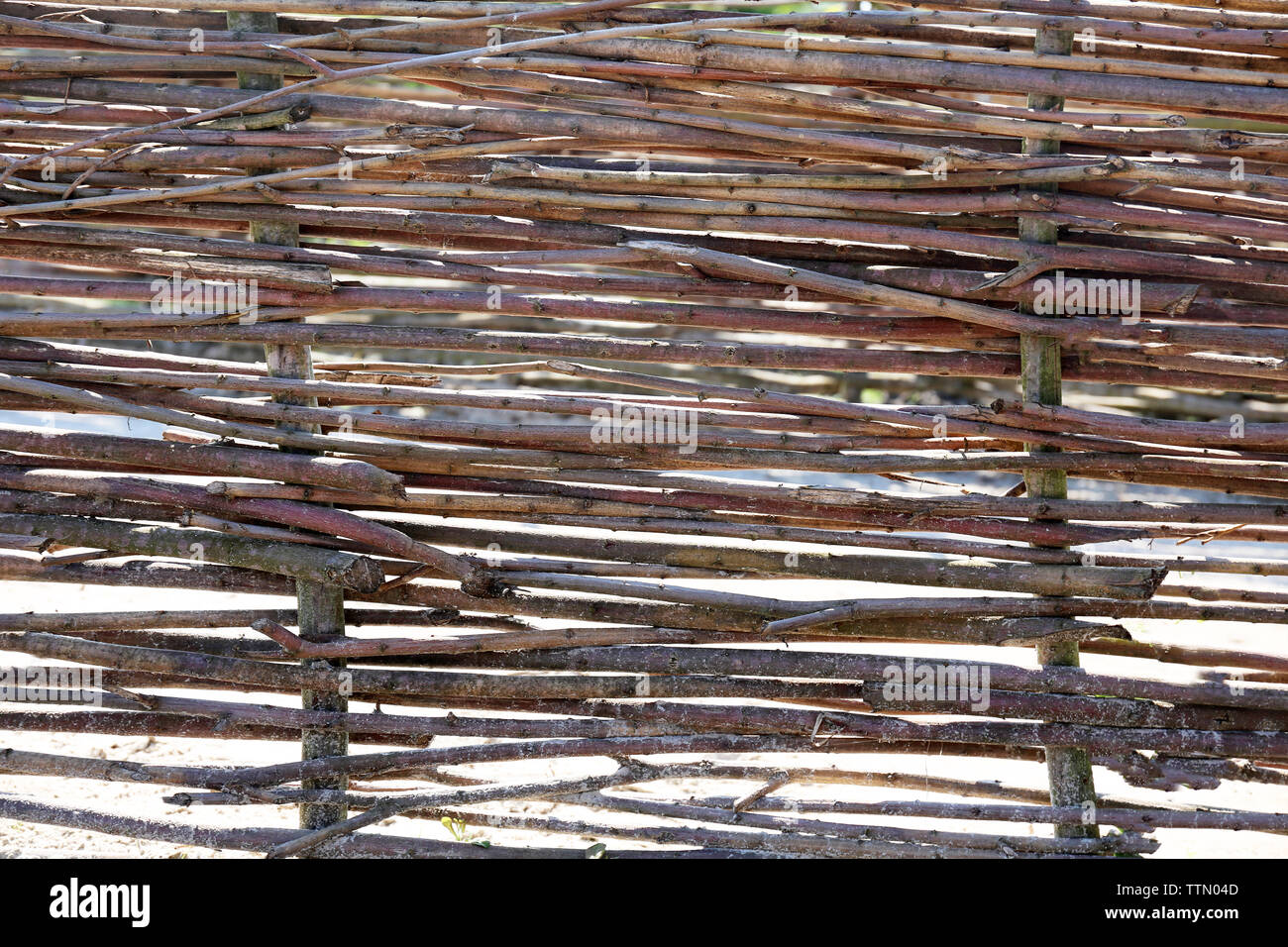 Wicker fence made of sticks Stock Photo - Alamy