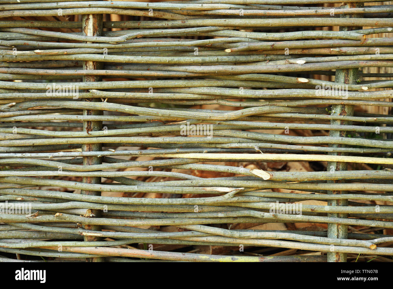 Wicker fence made of sticks Stock Photo - Alamy