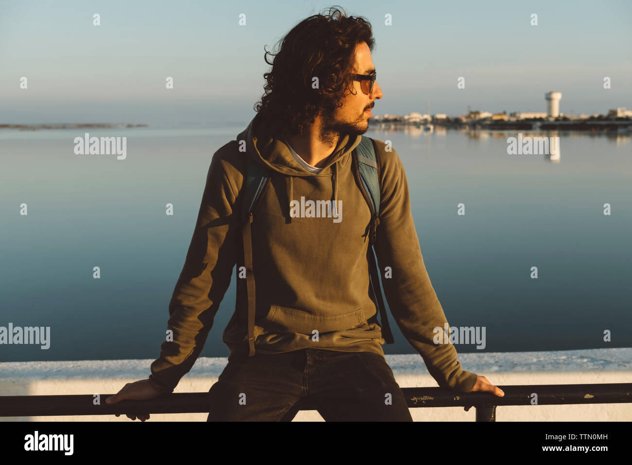 Man sitting on railing hi-res stock photography and images - Alamy