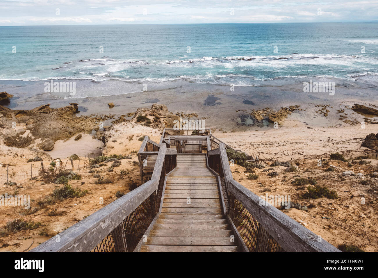 Scenic view of sea with wooden steps at beach Stock Photo - Alamy